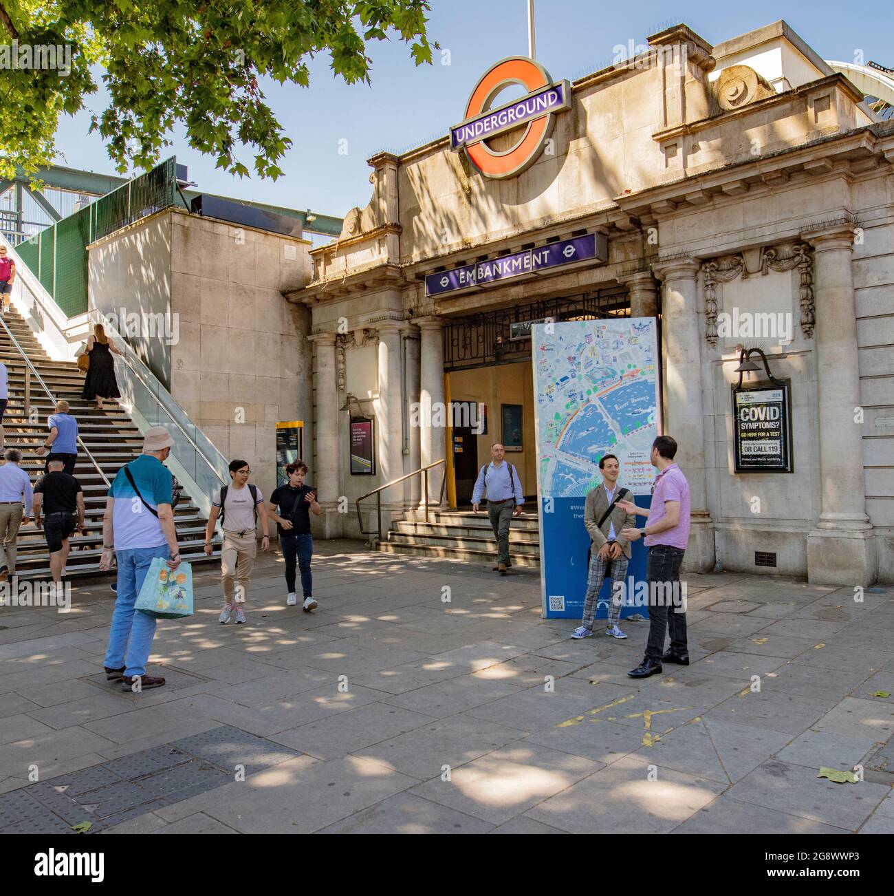 Tourists outside Embankment Station Underground, London; Victoria ...