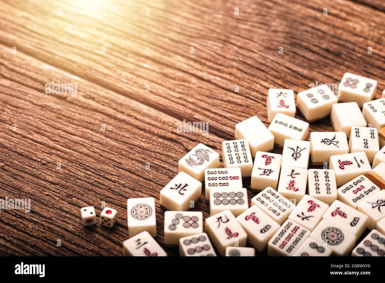 Many old mahjong tiles on wooden table. Mahjong is the ancient asian ...