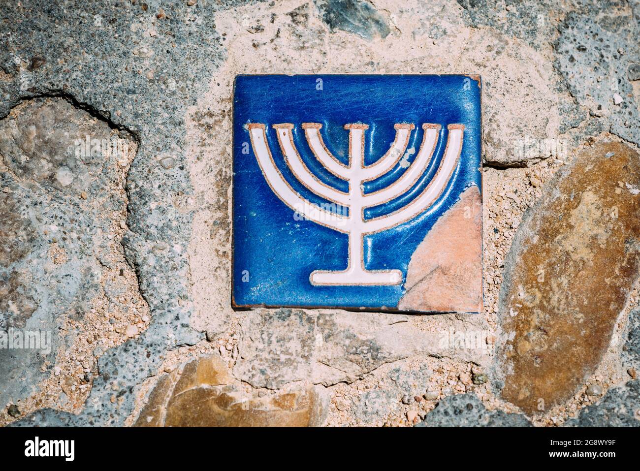Jewish menorah symbol on the wall in Toledo's Jewish District, Spain ...