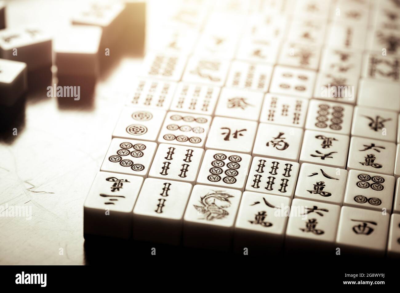 Many old mahjong tiles on wooden table. Mahjong is the ancient asian ...