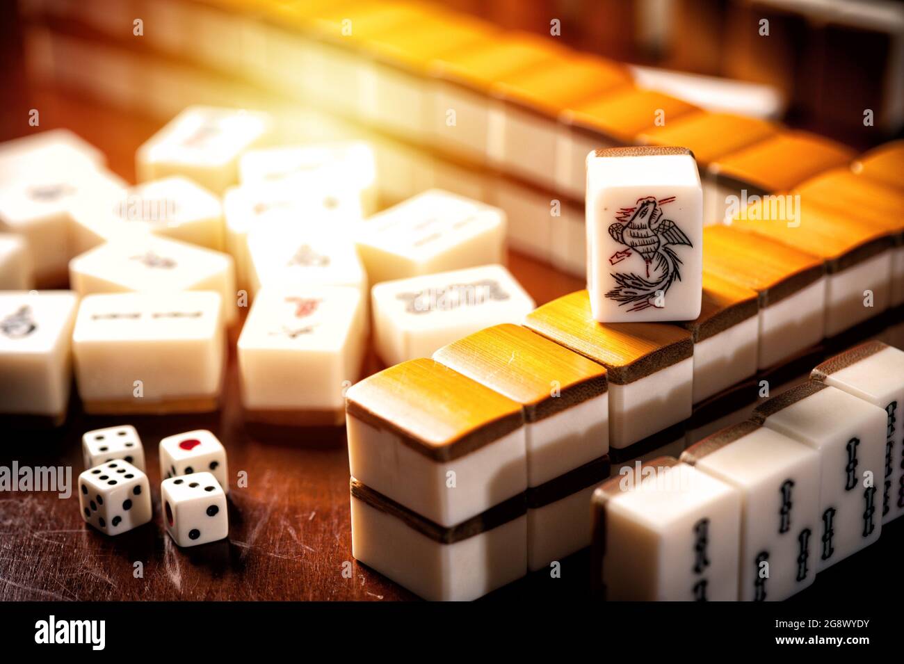 Many old mahjong tiles on wooden table. Mahjong is the ancient asian ...