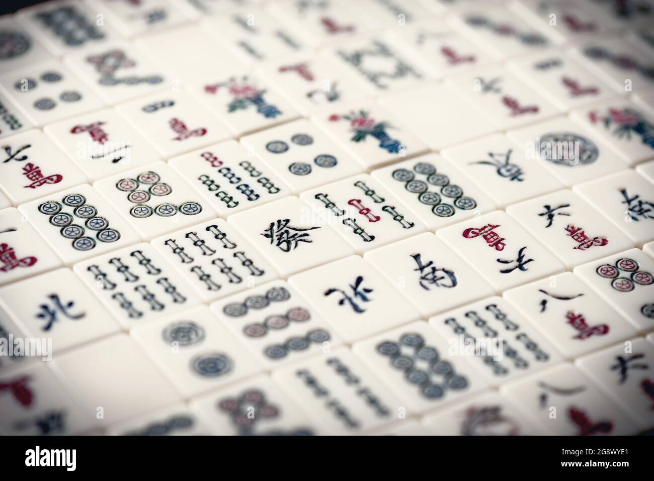 Many old mahjong tiles on wooden table. Mahjong is the ancient asian ...