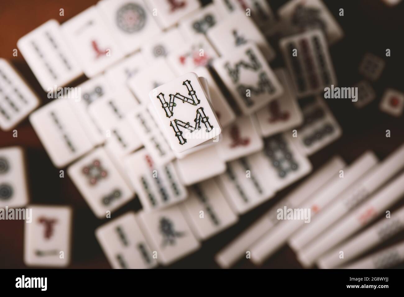 Many old mahjong tiles on wooden table. Mahjong is the ancient asian ...