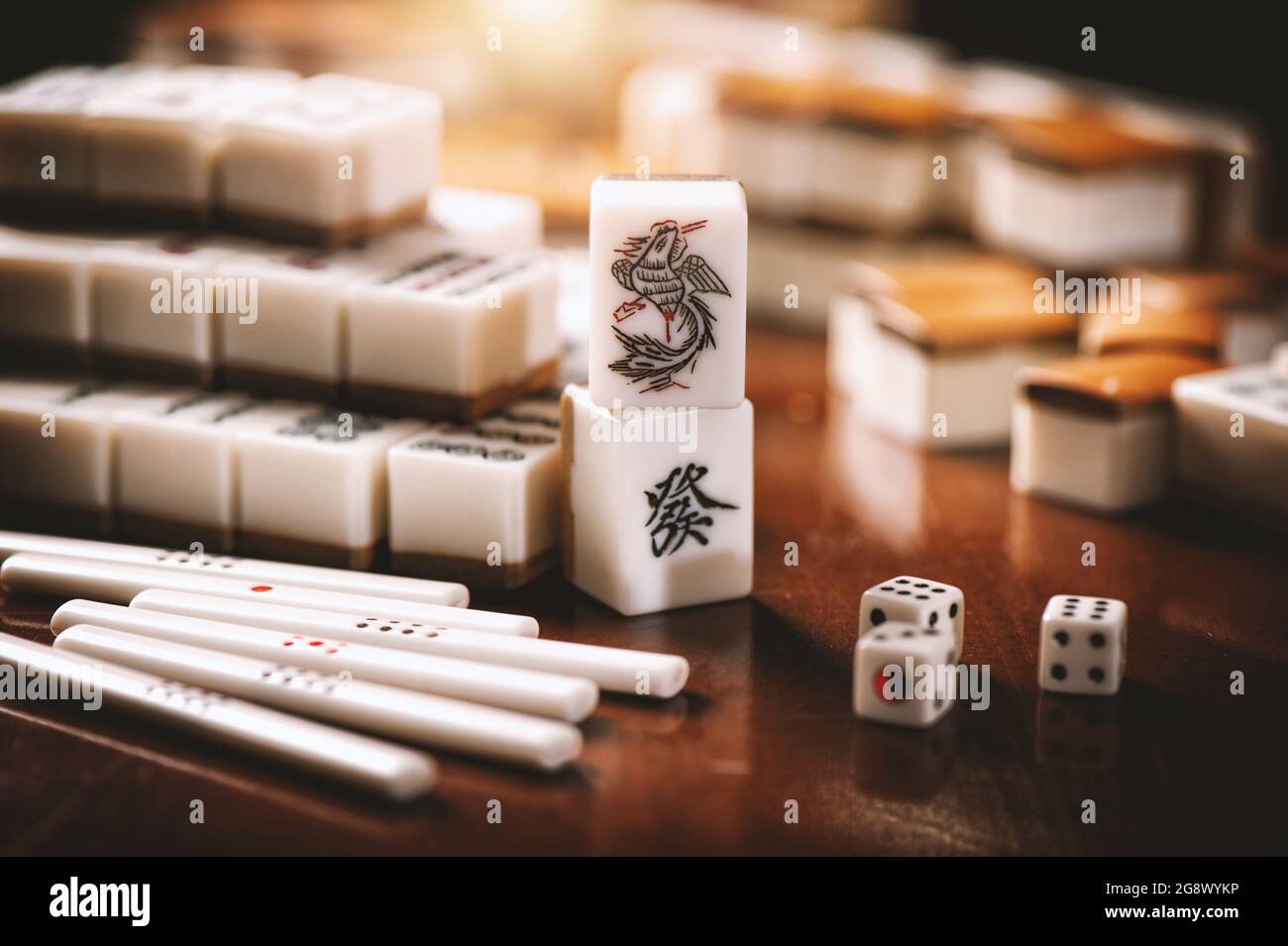 Many old mahjong tiles on wooden table. Mahjong is the ancient asian ...