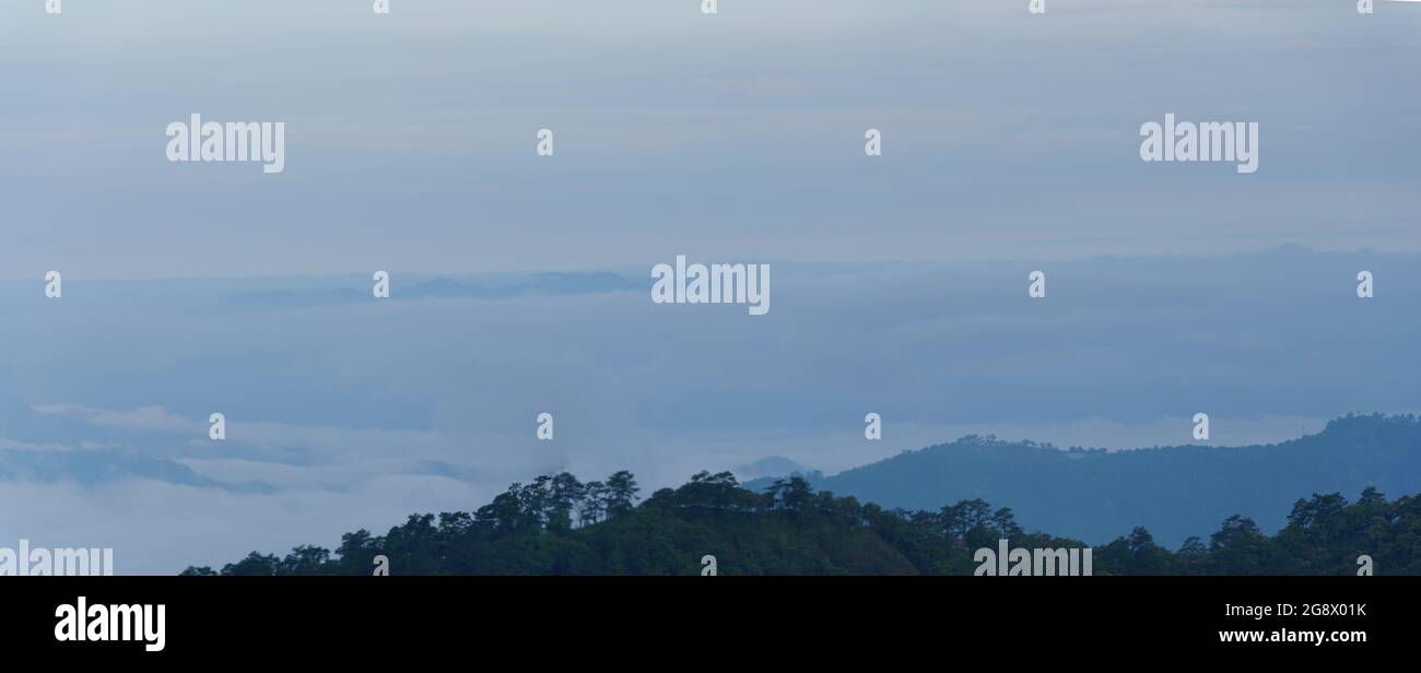Panoramic shot of clouds on top of the mountain ranges Stock Photo - Alamy
