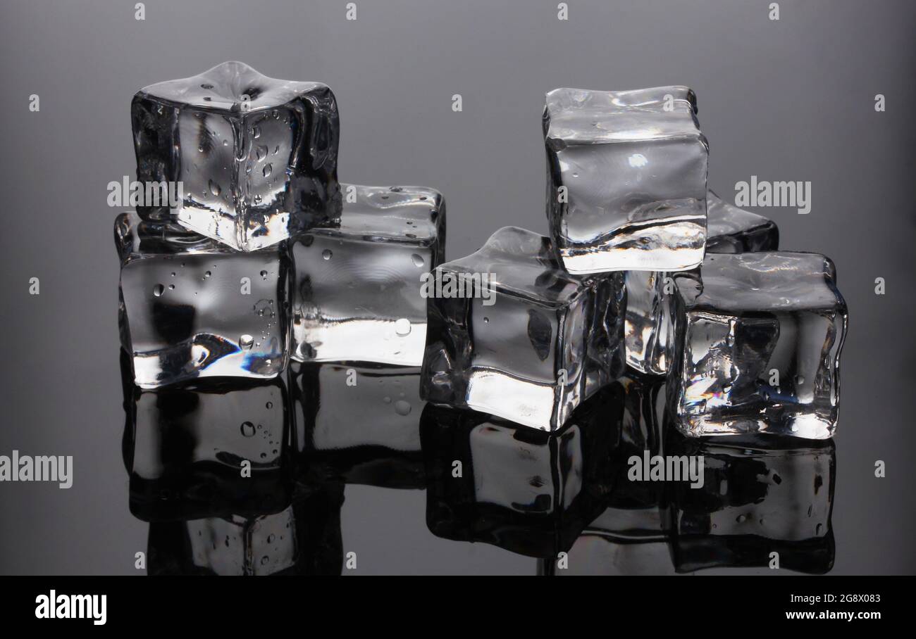 Ice cubes on grey background Stock Photo - Alamy