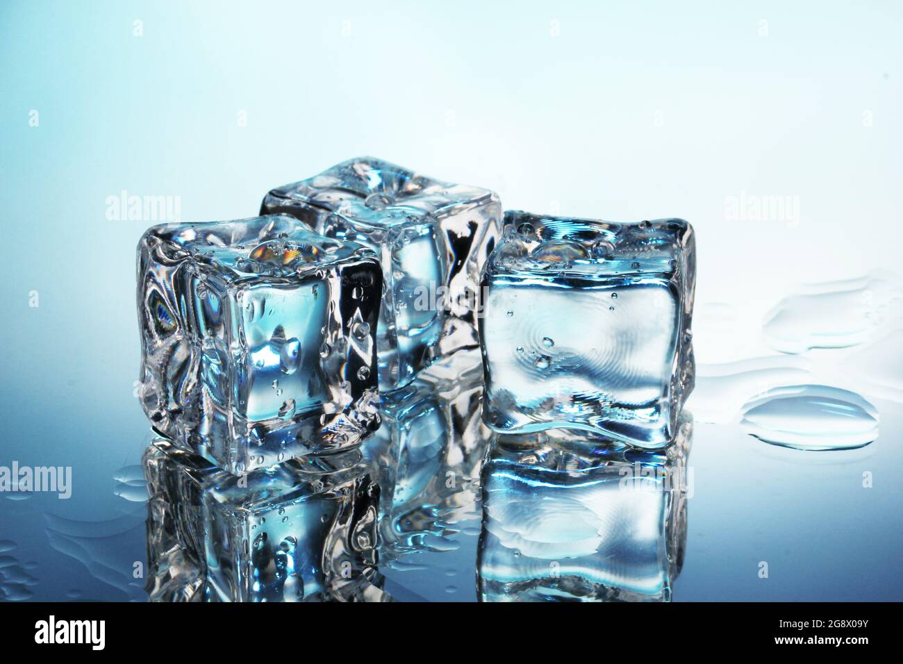 Melting ice cubes on blue background Stock Photo - Alamy