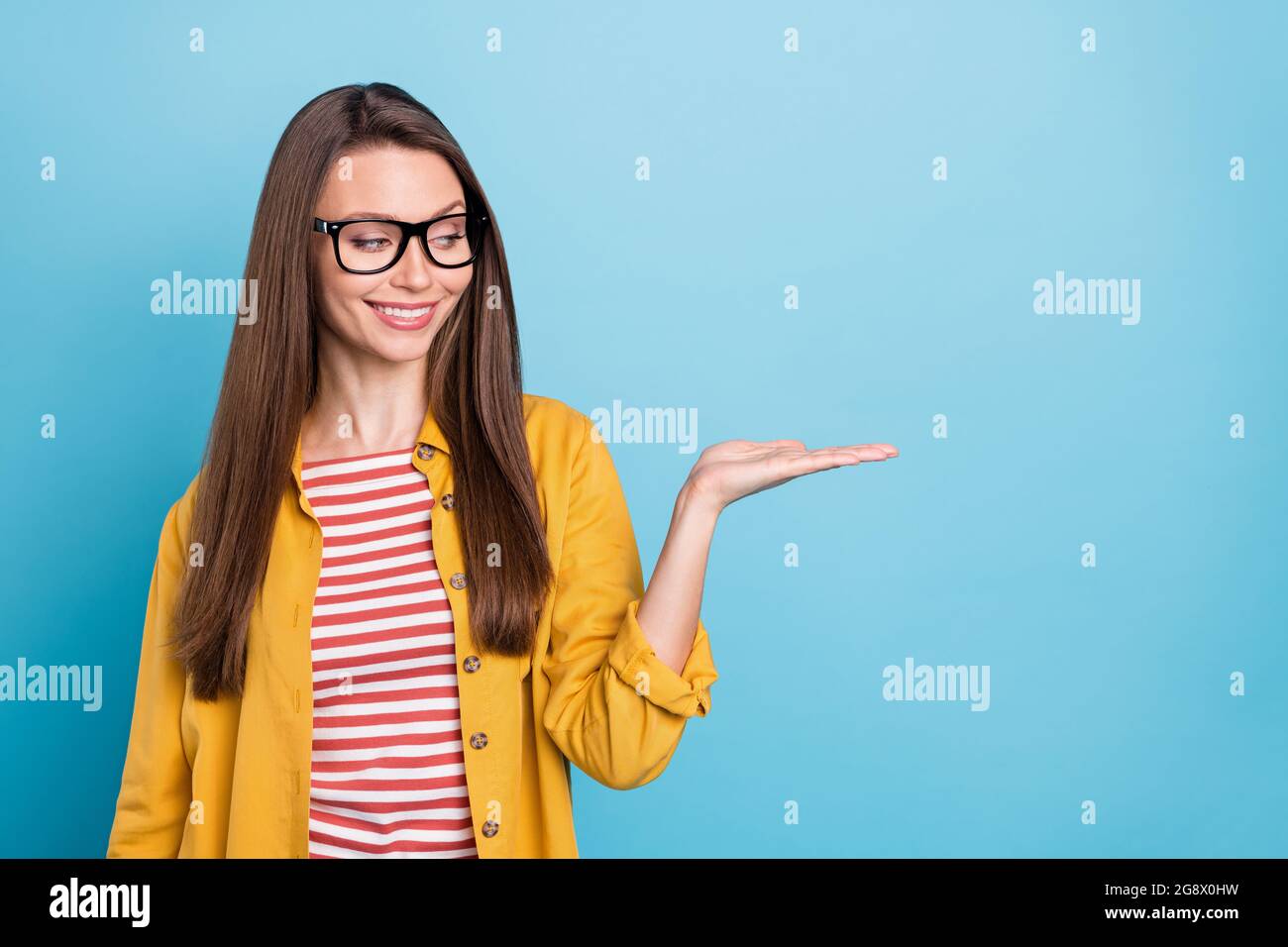 Photo of young attractive woman happy smile look hand present promo ...