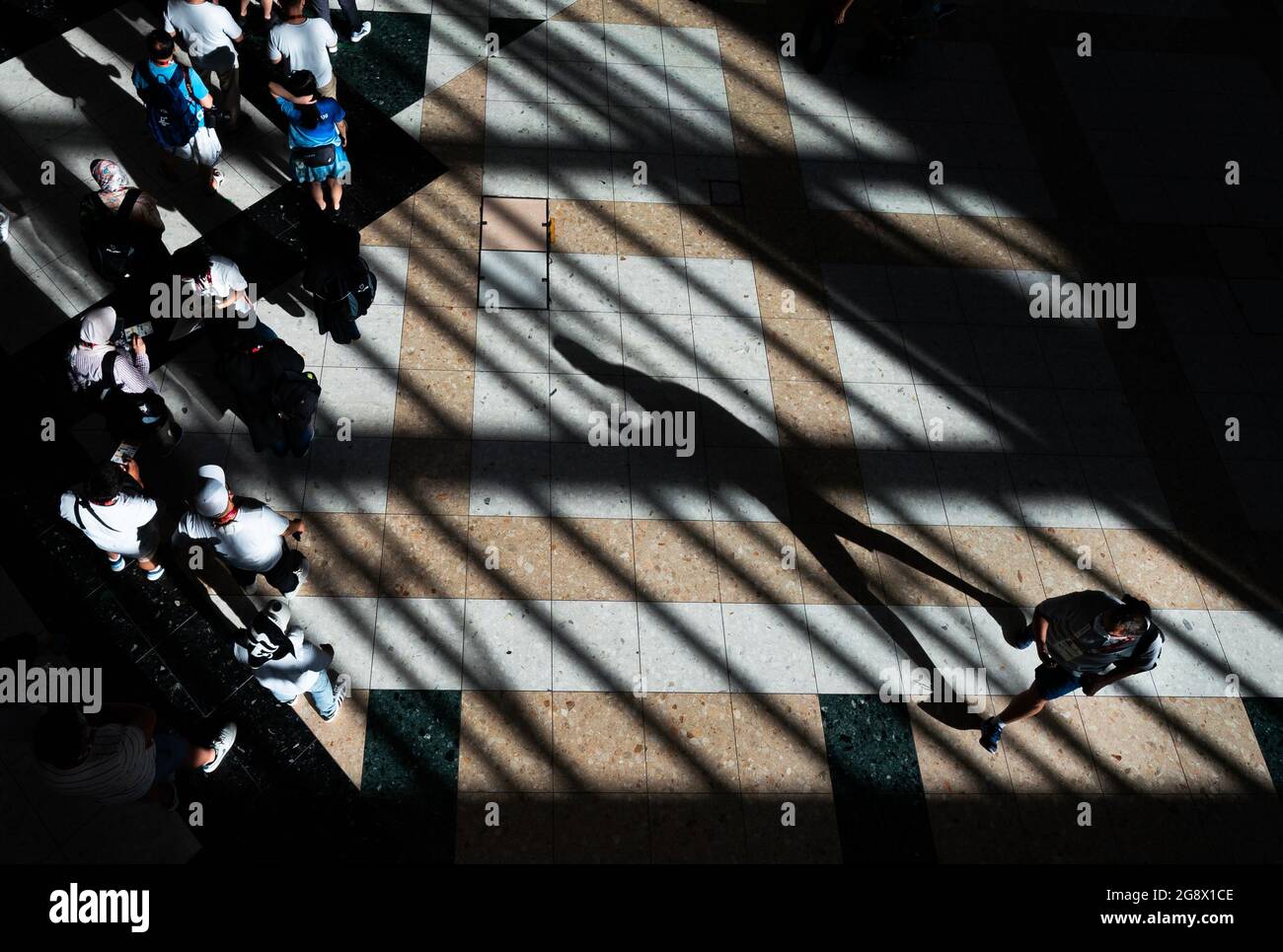 A man casts a shadow has he walks through the Main Press Centre in ...