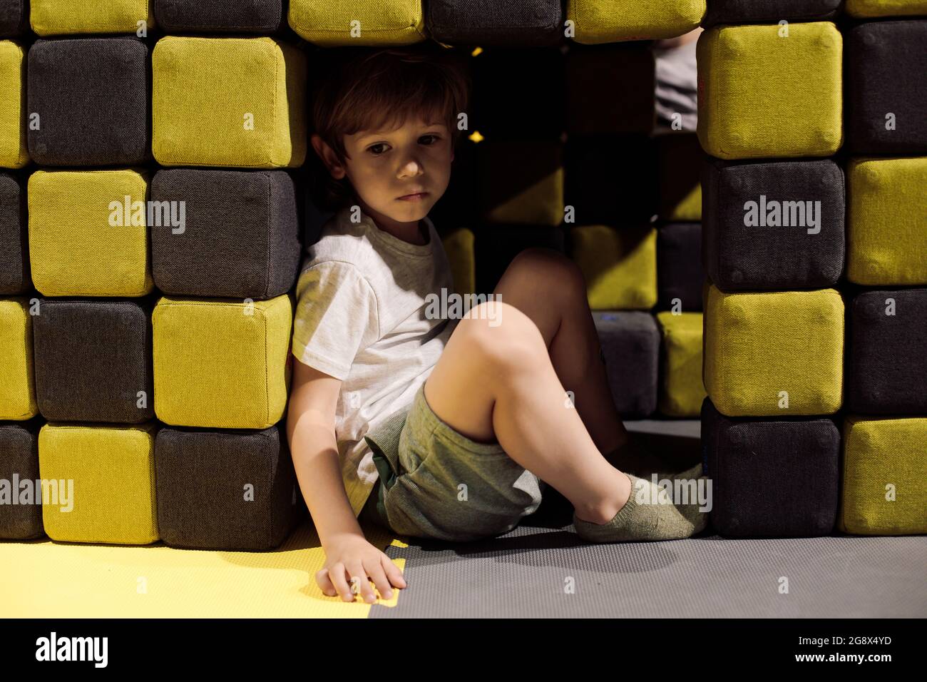 Child was sad in children's play center among soft cubic blocks ...