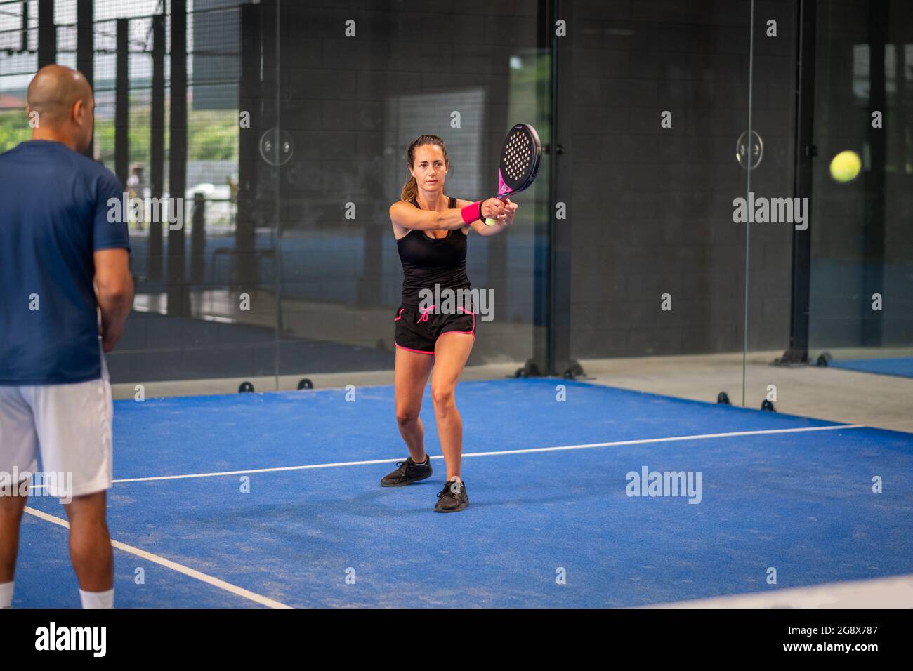 Monitor teaching padel class to woman, his student - Trainer teaches ...