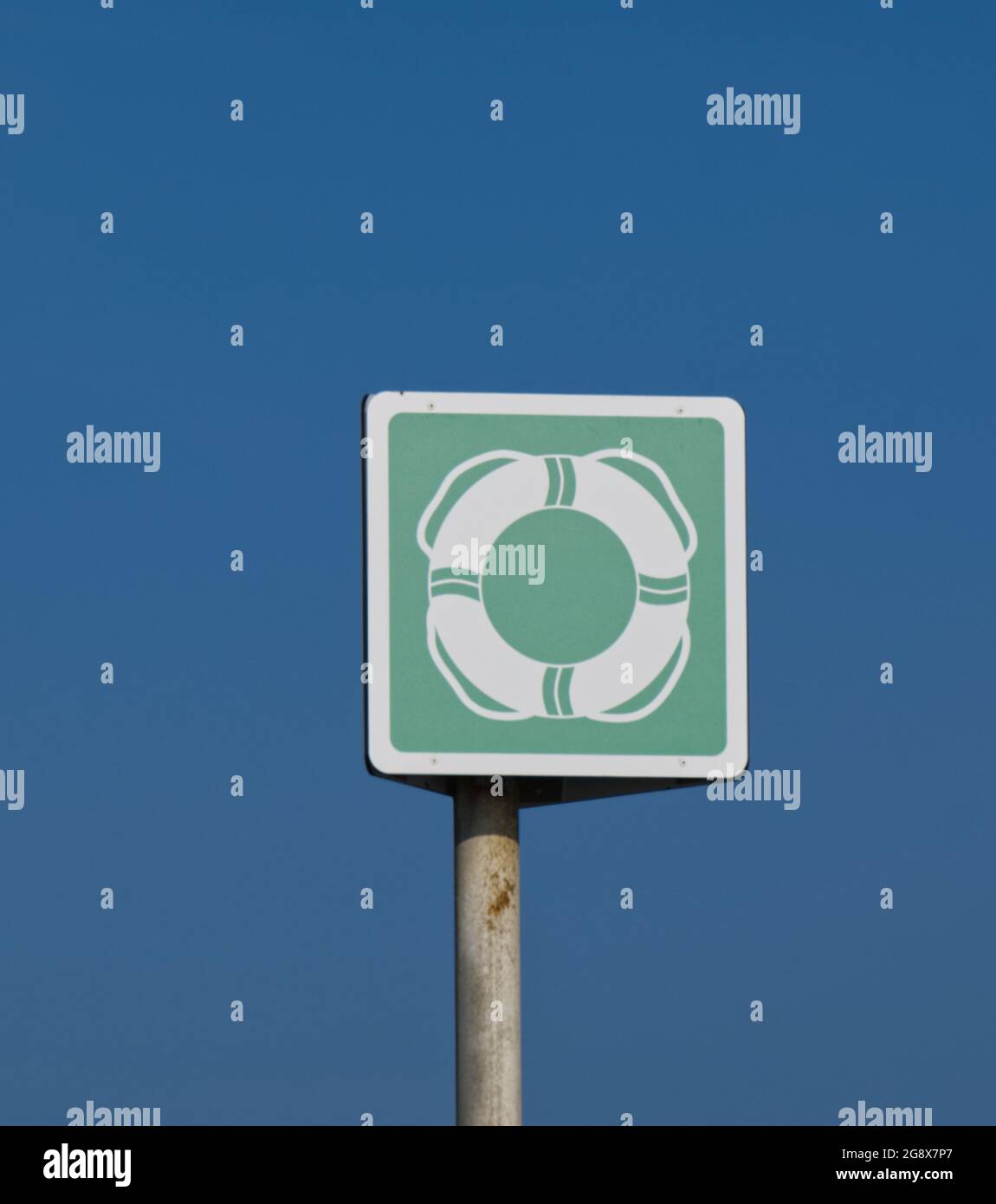 White and pale green sign indicating the location of a life bouy ...