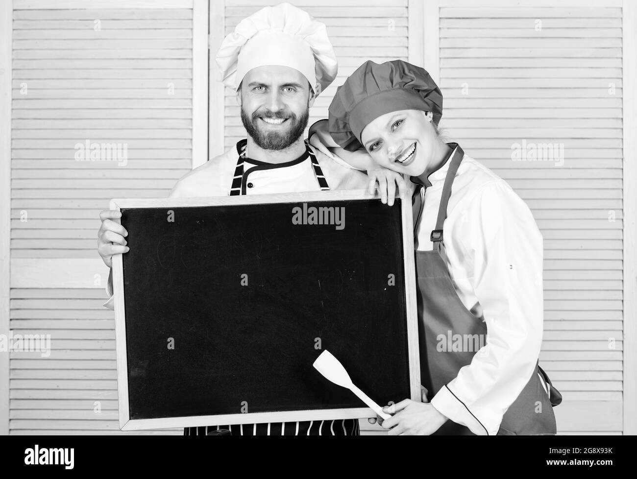 Mastering cooking skills. Couple of man and woman holding empty ...