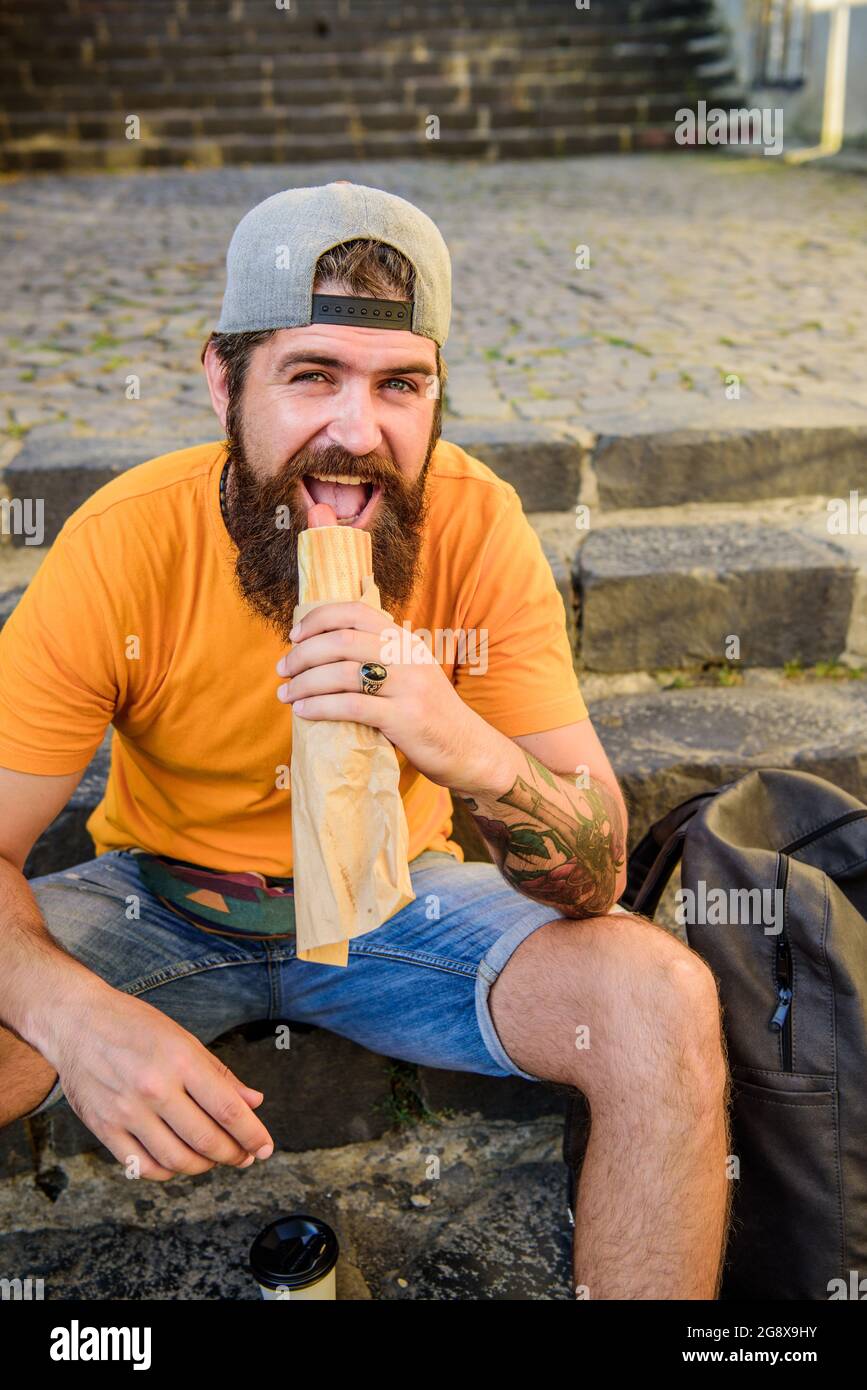 Junk food. Guy eating hot dog. Man bearded enjoy quick snack. Street ...