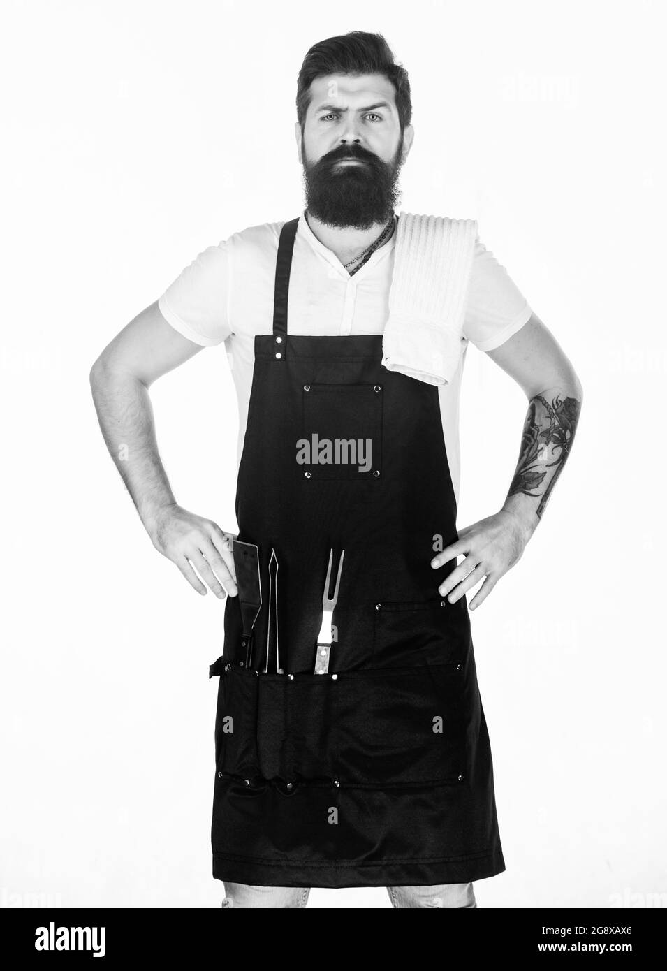 Bearded hipster wear apron for barbecue. Roasting and grilling food ...