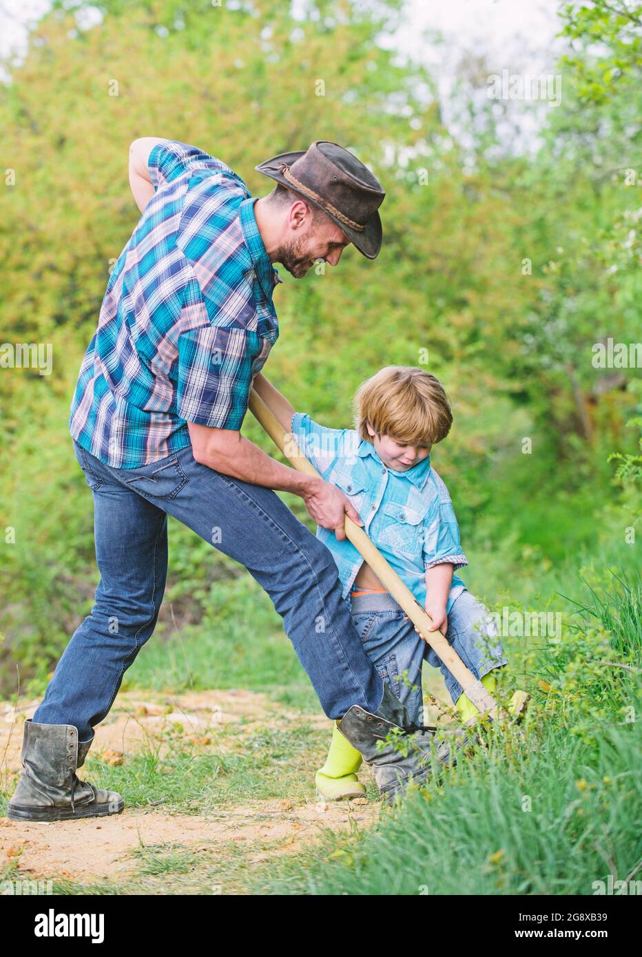 Little helper in garden. Cute child in nature having fun with cowboy ...