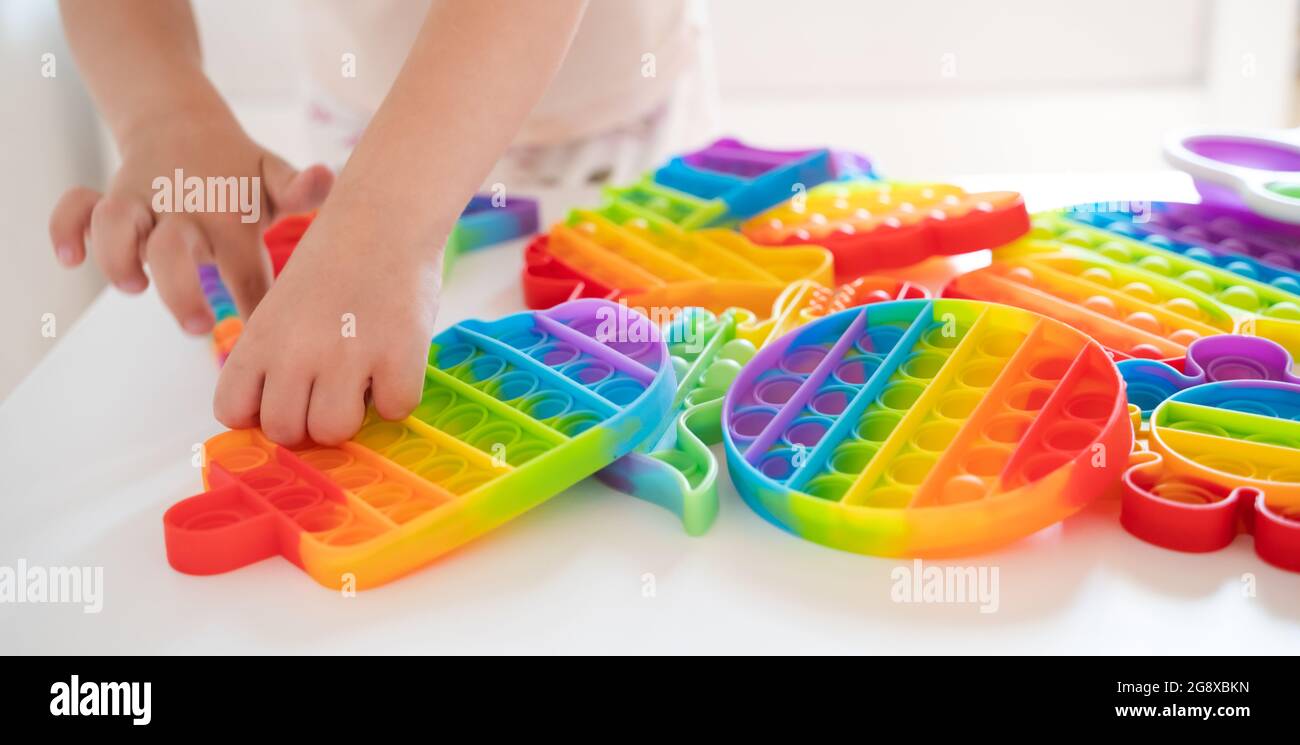 Little girl,kid,child plays with colorful pop it children's room ...