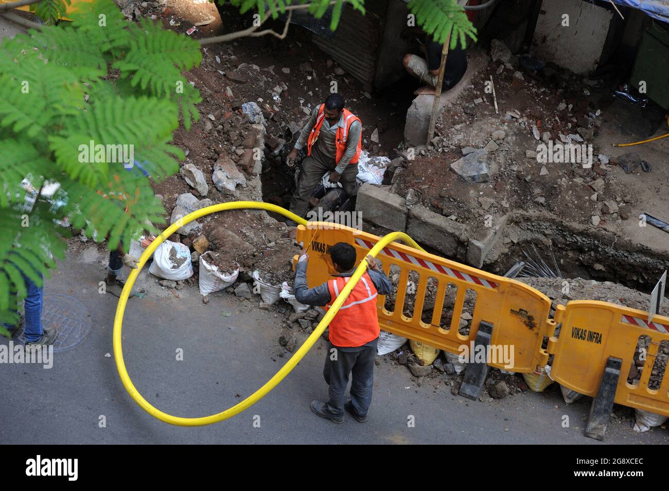 workers Pulling a fiber optic cable for fast internet and telephone ...