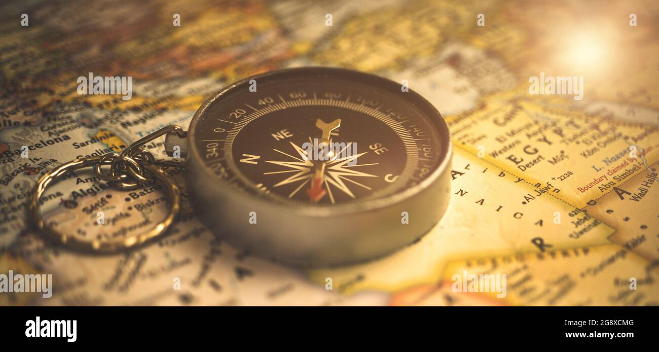 Old traveler compass on a vintage world map. Banner, exploration ...