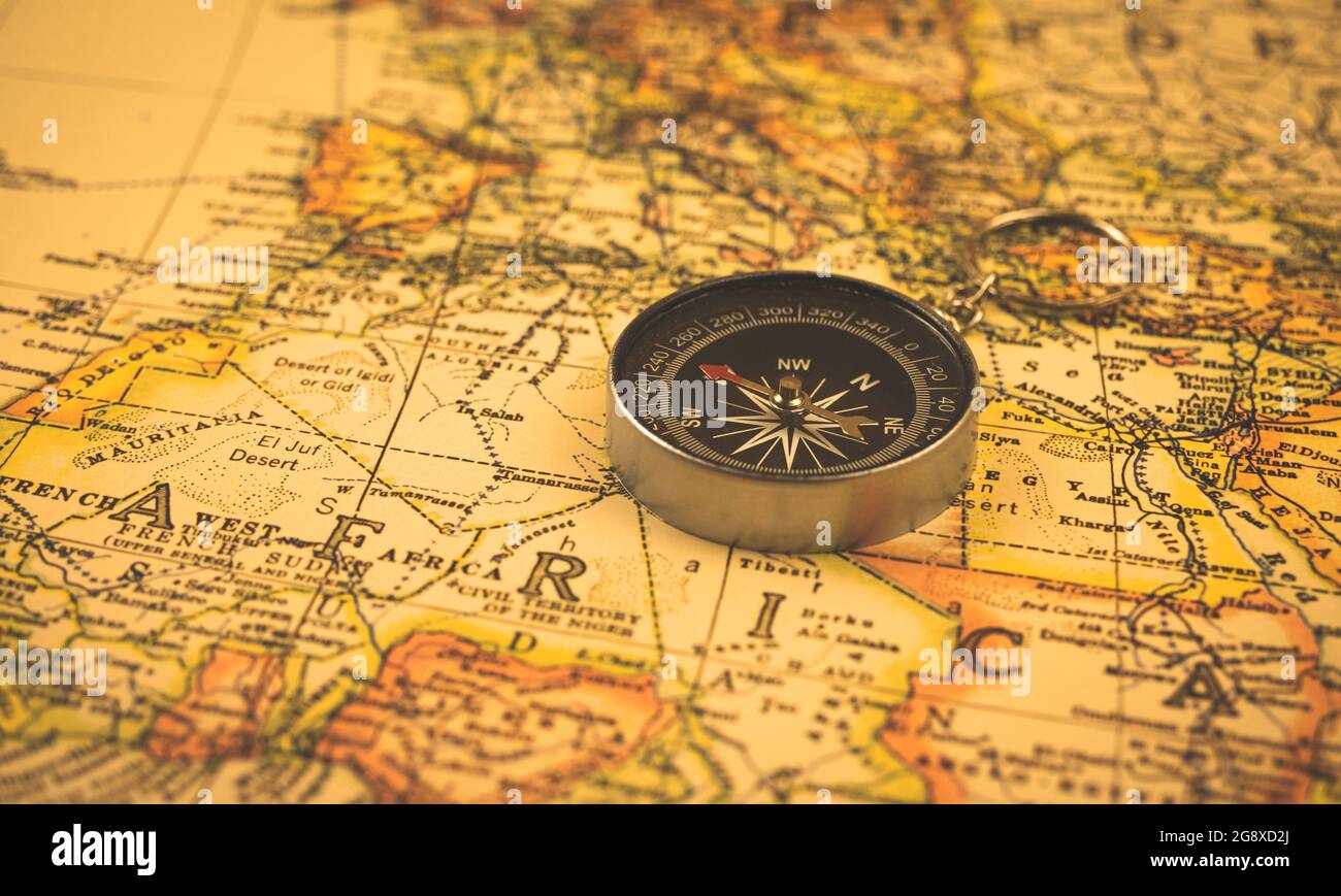 Antique compass on vintage africa travel map, exploration and ...
