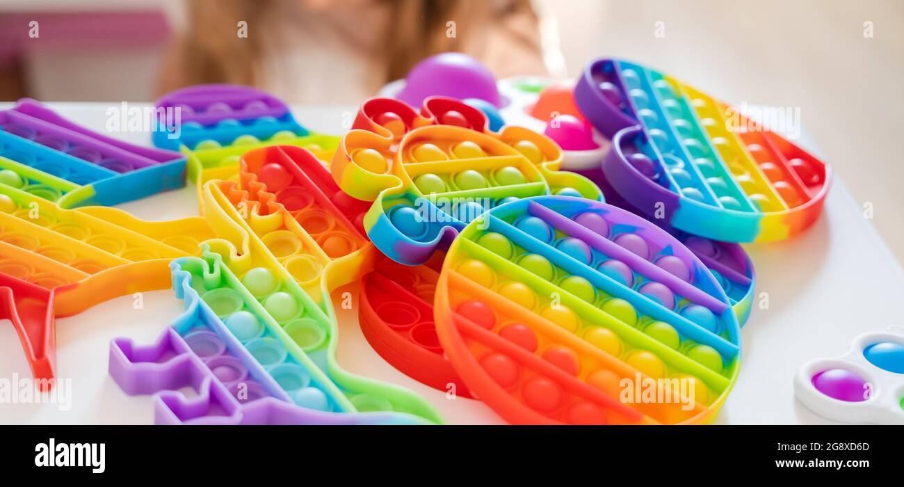 Little girl,kid,child plays with colorful pop it children's room ...