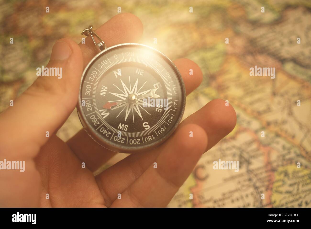 Man using compass on map hi-res stock photography and images - Alamy