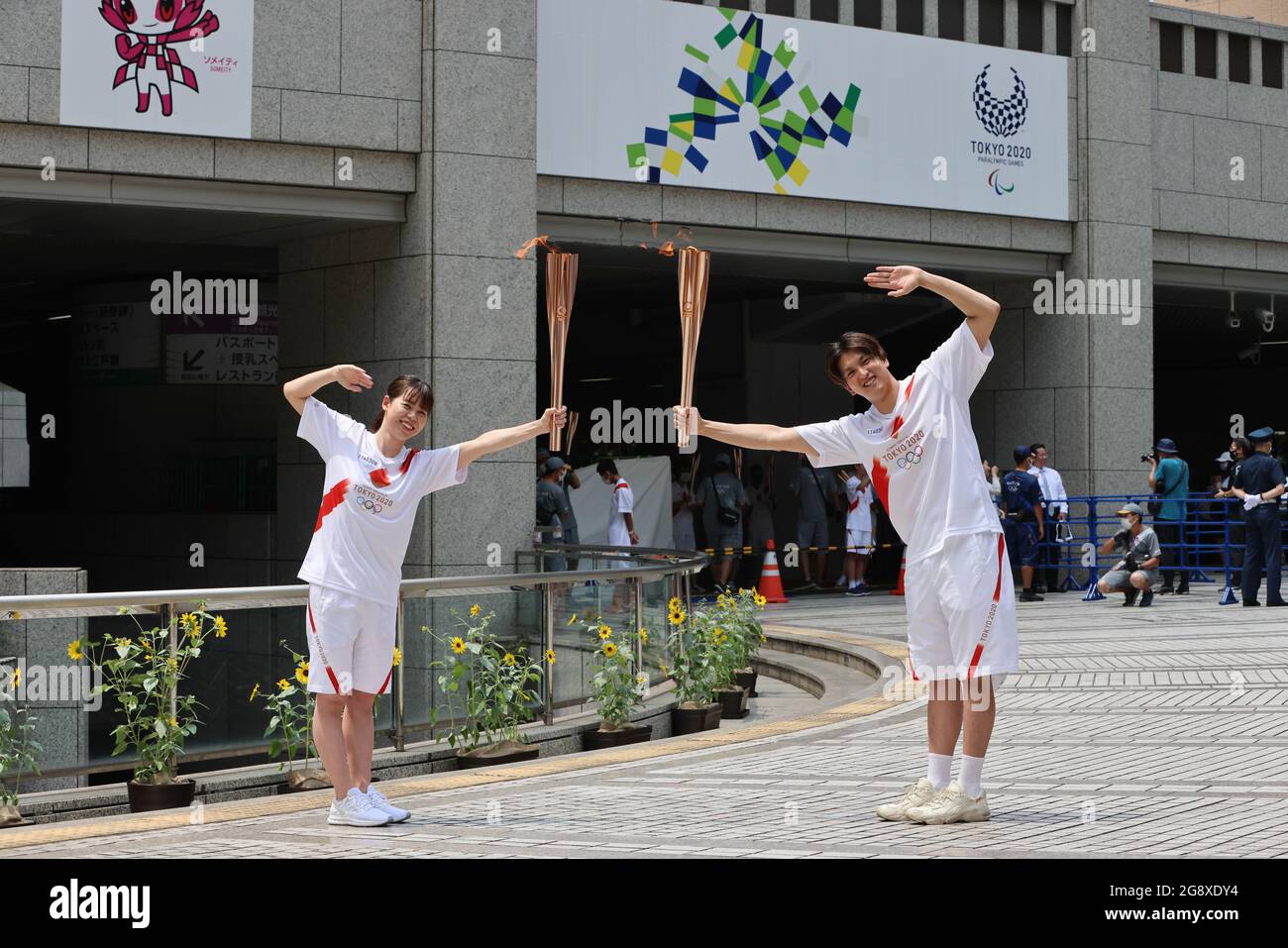 Torchbearers pose for a photo with the Olympic flame.Arrival Ceremony ...