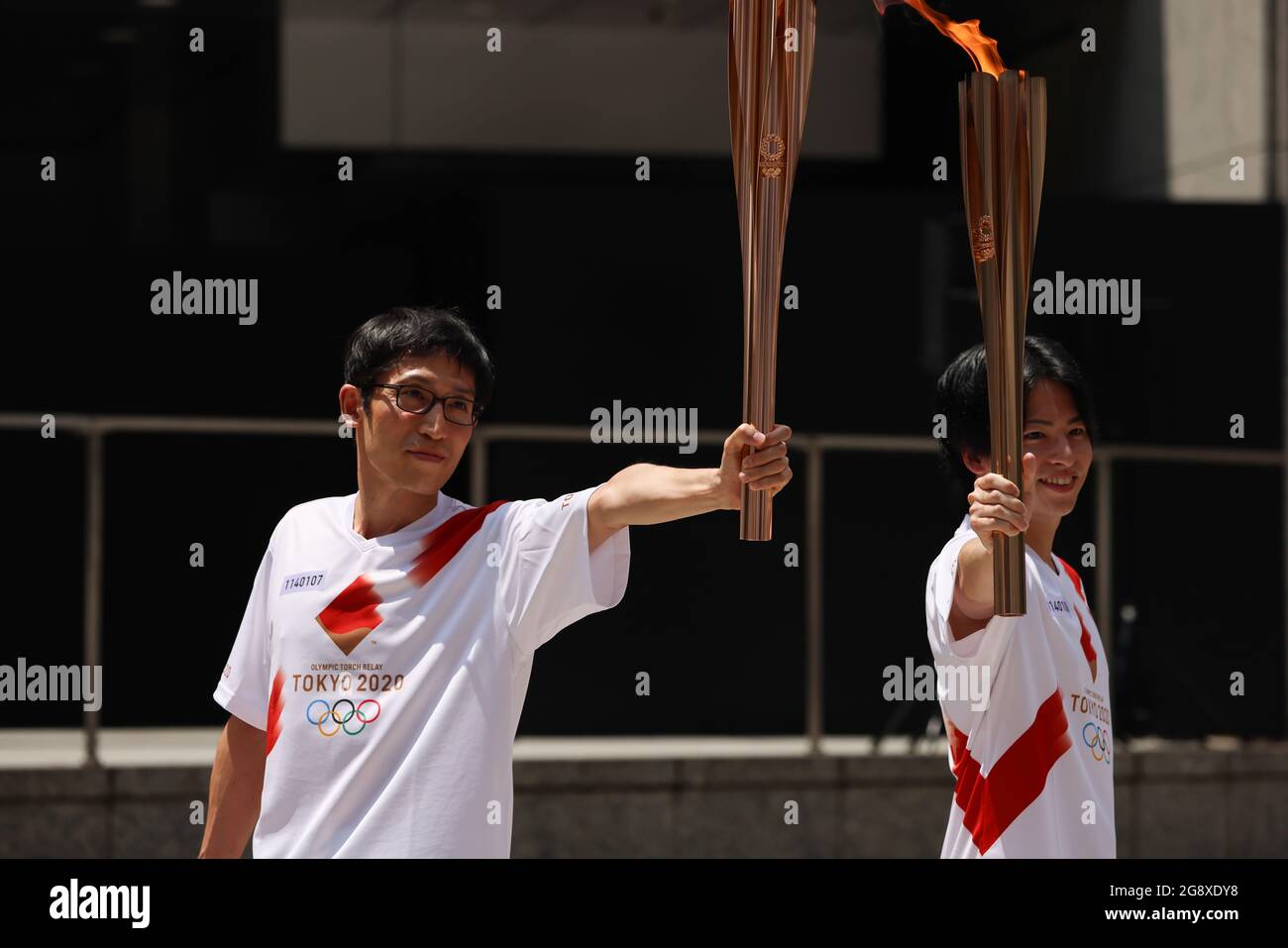 Torchbearers pose for a photo with the Olympic flame.Arrival Ceremony ...