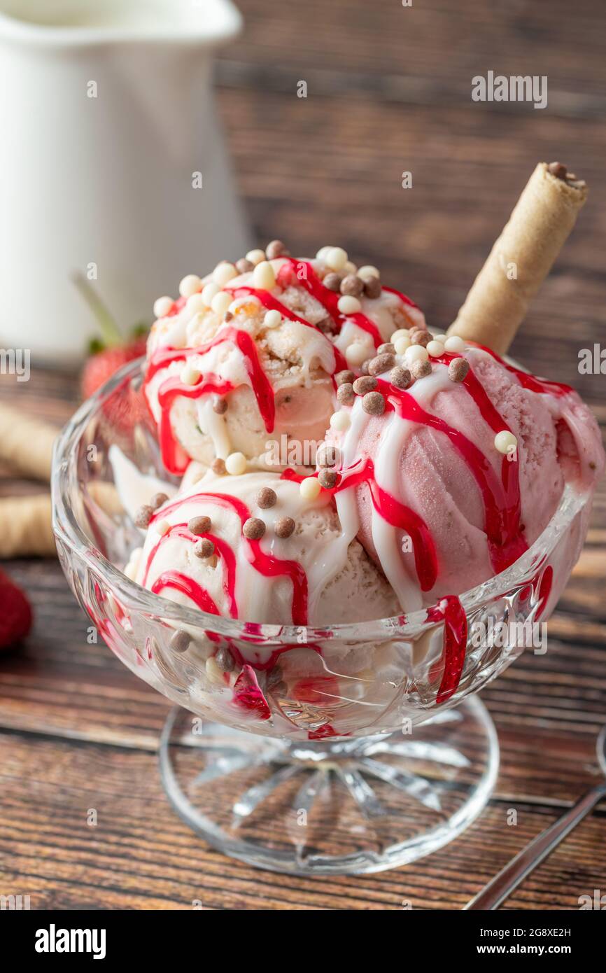 strawberry, banana and cream Roma ice cream in a glass bowl with red ...