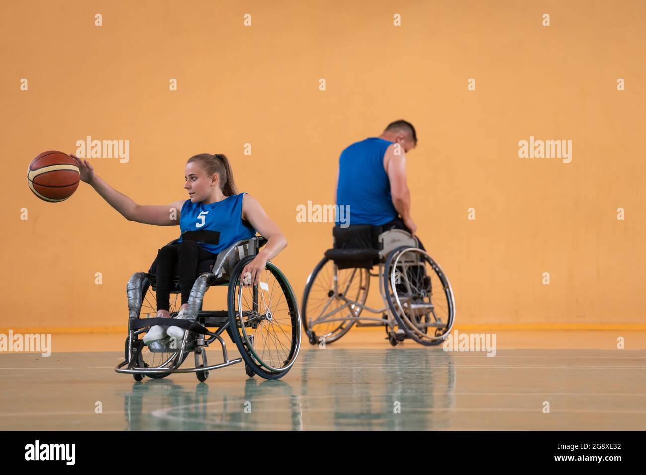 a young woman playing wheelchair basketball in a professional team ...