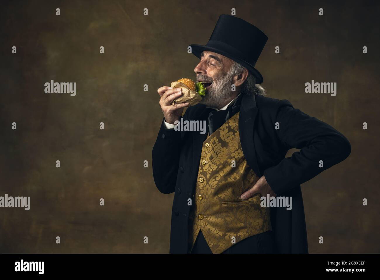 Handsome elderly gray-haired man, gentleman, aristocrat or actor eating ...