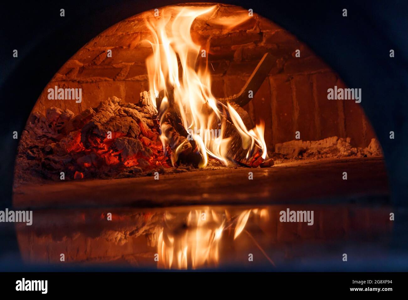 Close up detail of burning wood inside a classic oven to bake italian ...