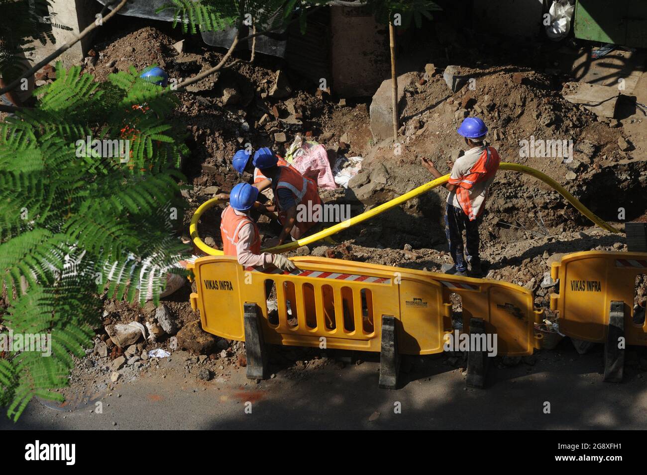 workers Pulling a fiber optic cable for fast internet and telephone ...