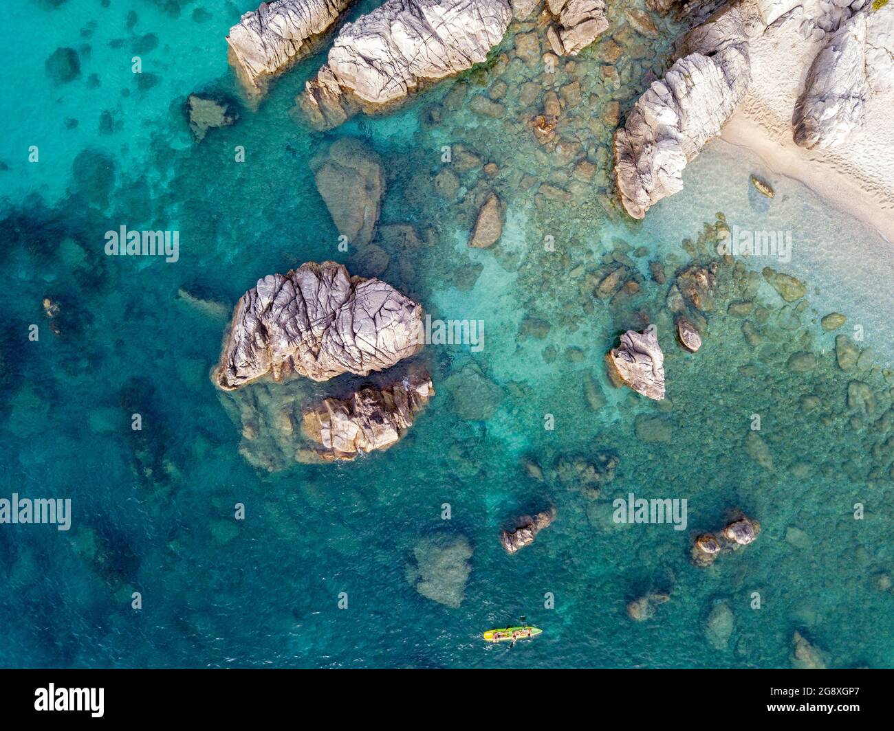 Aerial view of a canoe in the water floating on a transparent sea ...