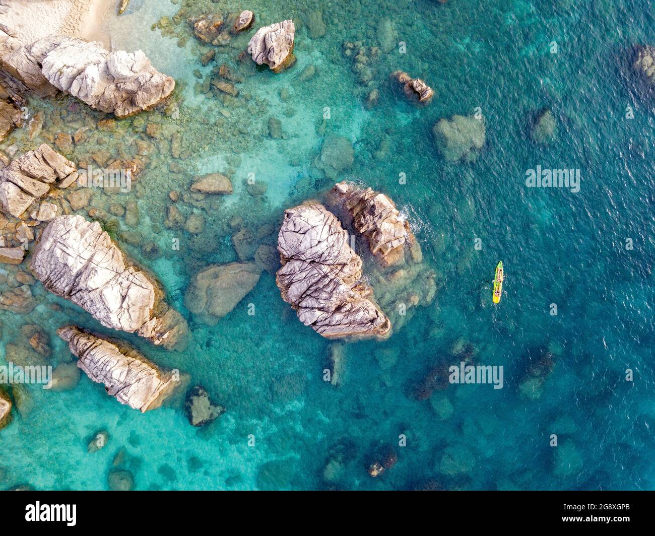 Aerial view of a canoe in the water floating on a transparent sea ...
