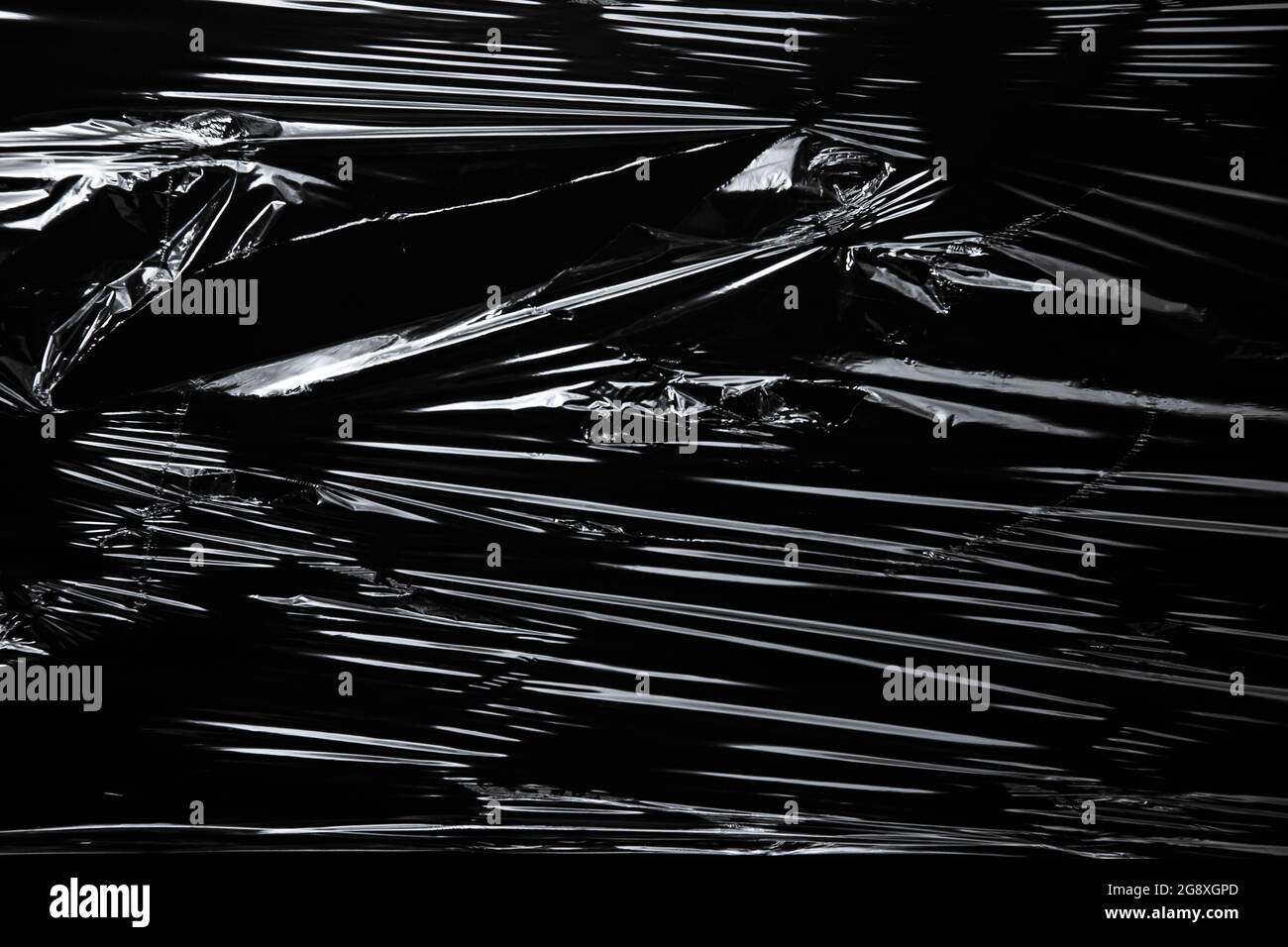 Image of the polyethylene wrap on black background Stock Photo - Alamy