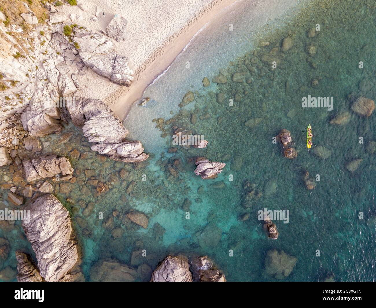 Aerial view of a canoe in the water floating on a transparent sea ...