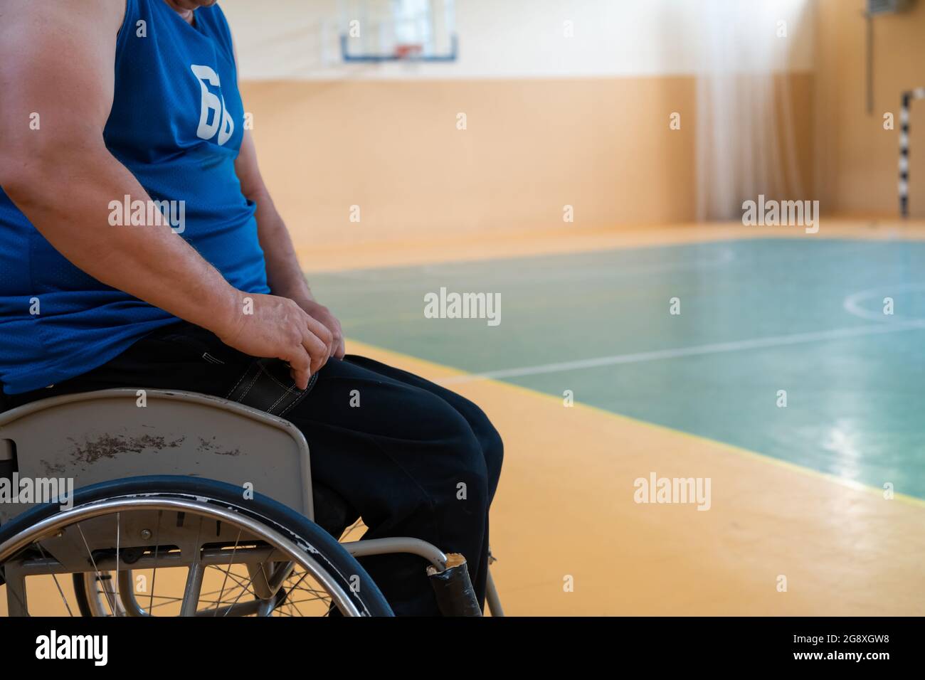 a handicapped basketball player prepares for a match while sitting in a ...