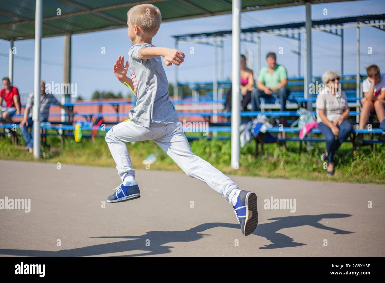 The child is running. Schoolboy at a running competition. The child ...