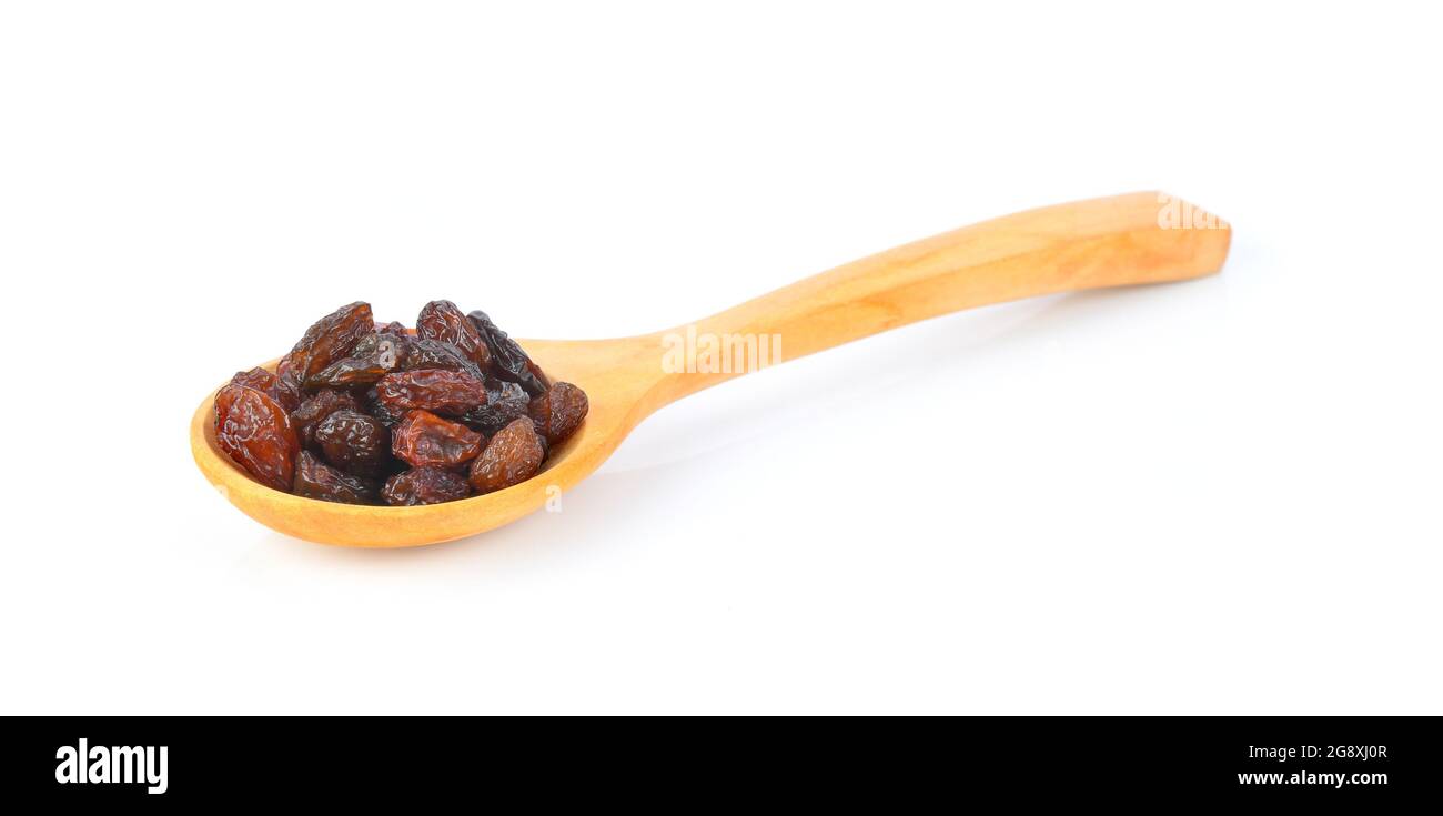 raisin in wood spoon isolated on white background Stock Photo - Alamy