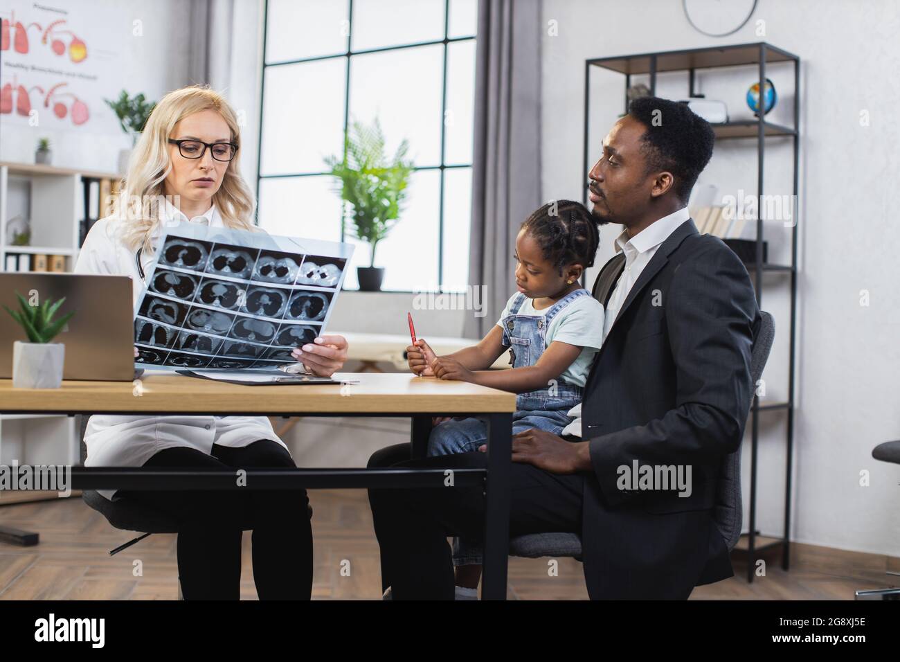 Handsome young african american father with his adorable little ...