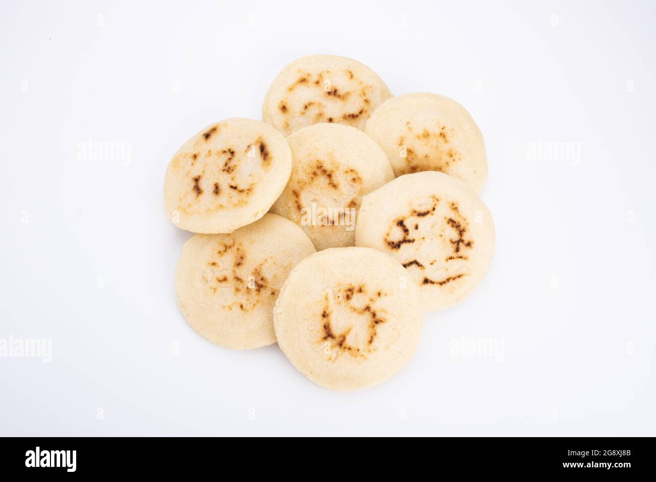 Stack of arepas made with corn flour on a white background, typical ...