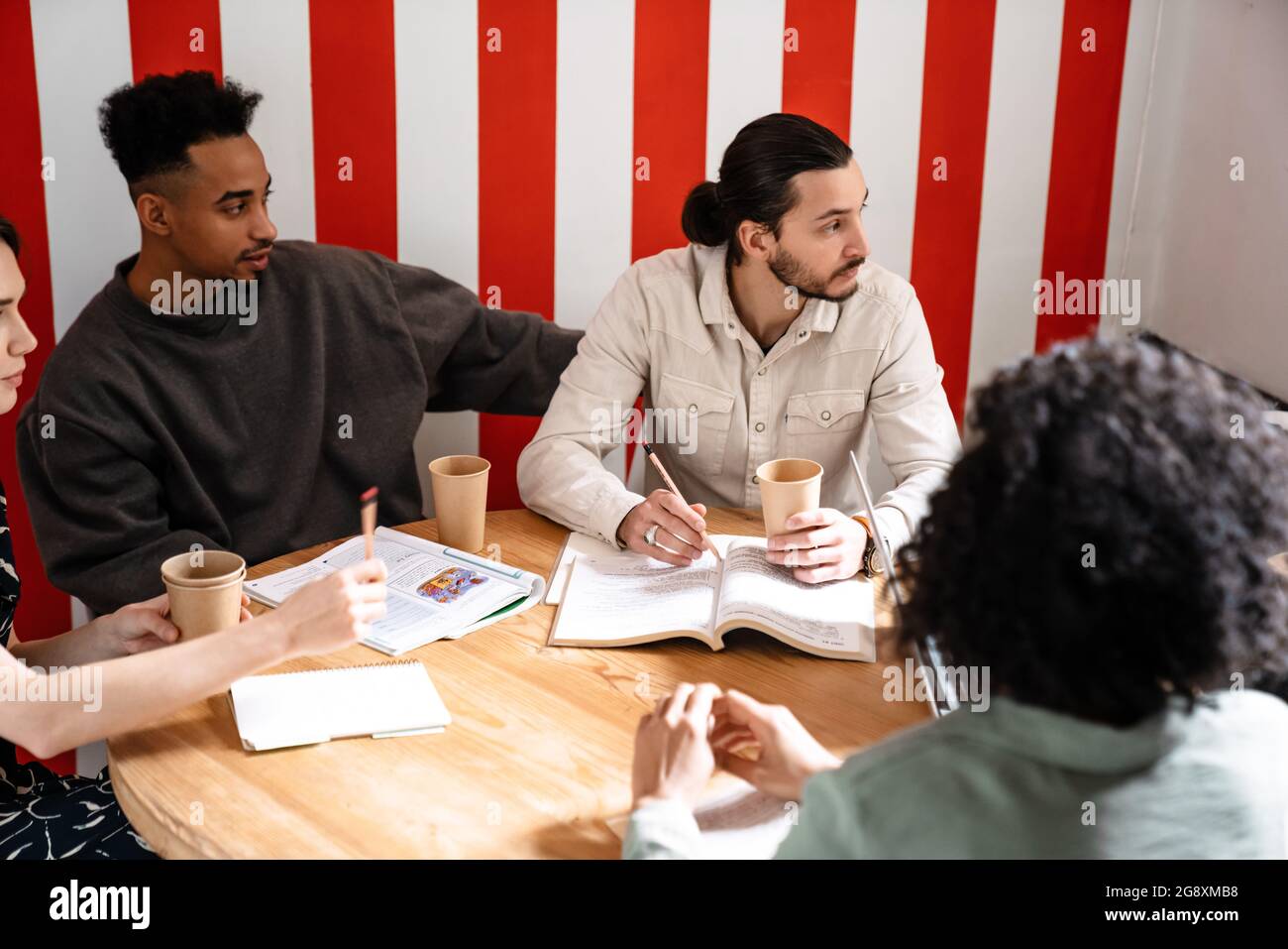 Mixed-race group shares ideas creative thoughts with multi-ethnic mates ...