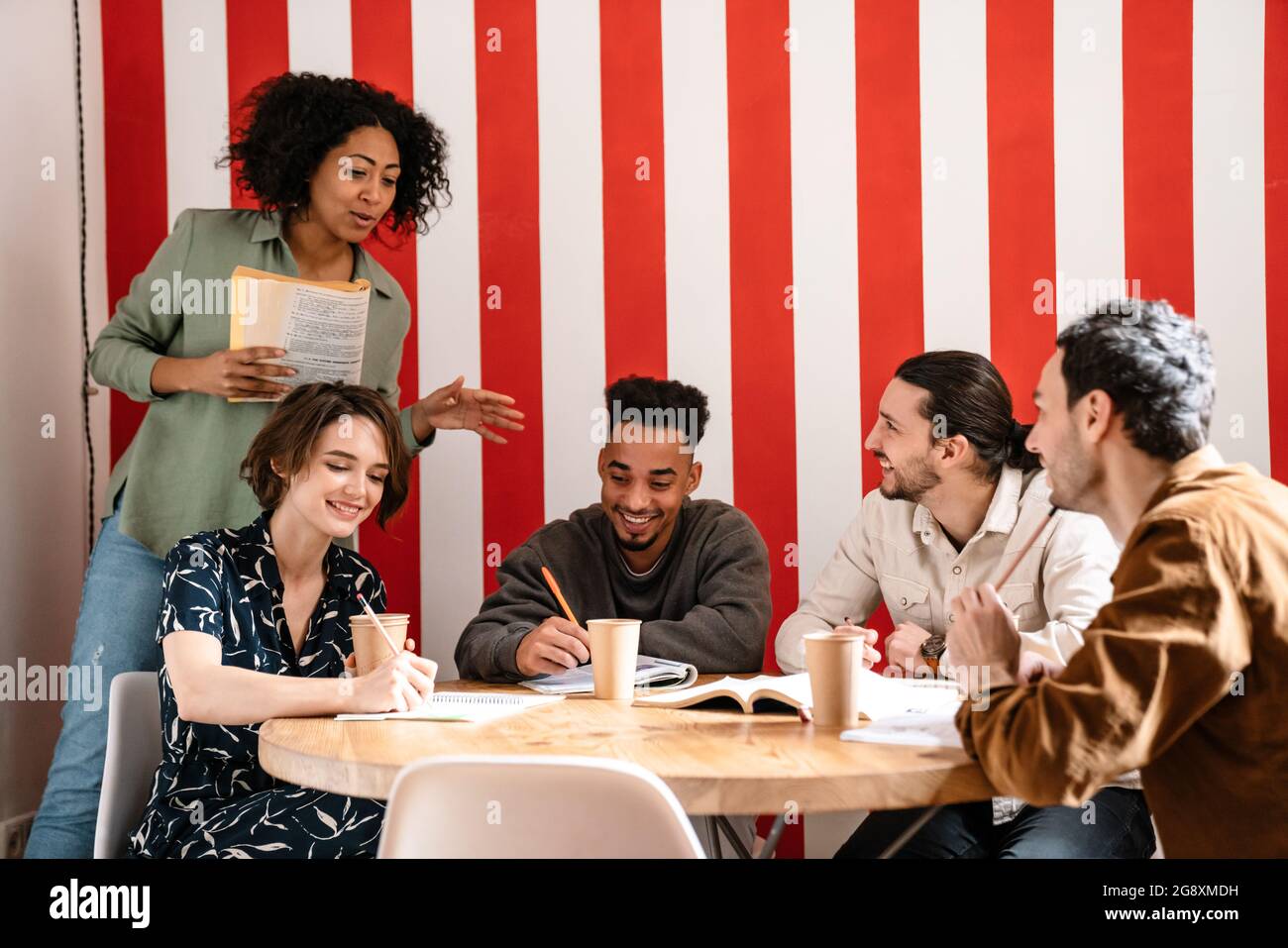 Mixed-race group shares ideas creative thoughts with multi-ethnic mates ...