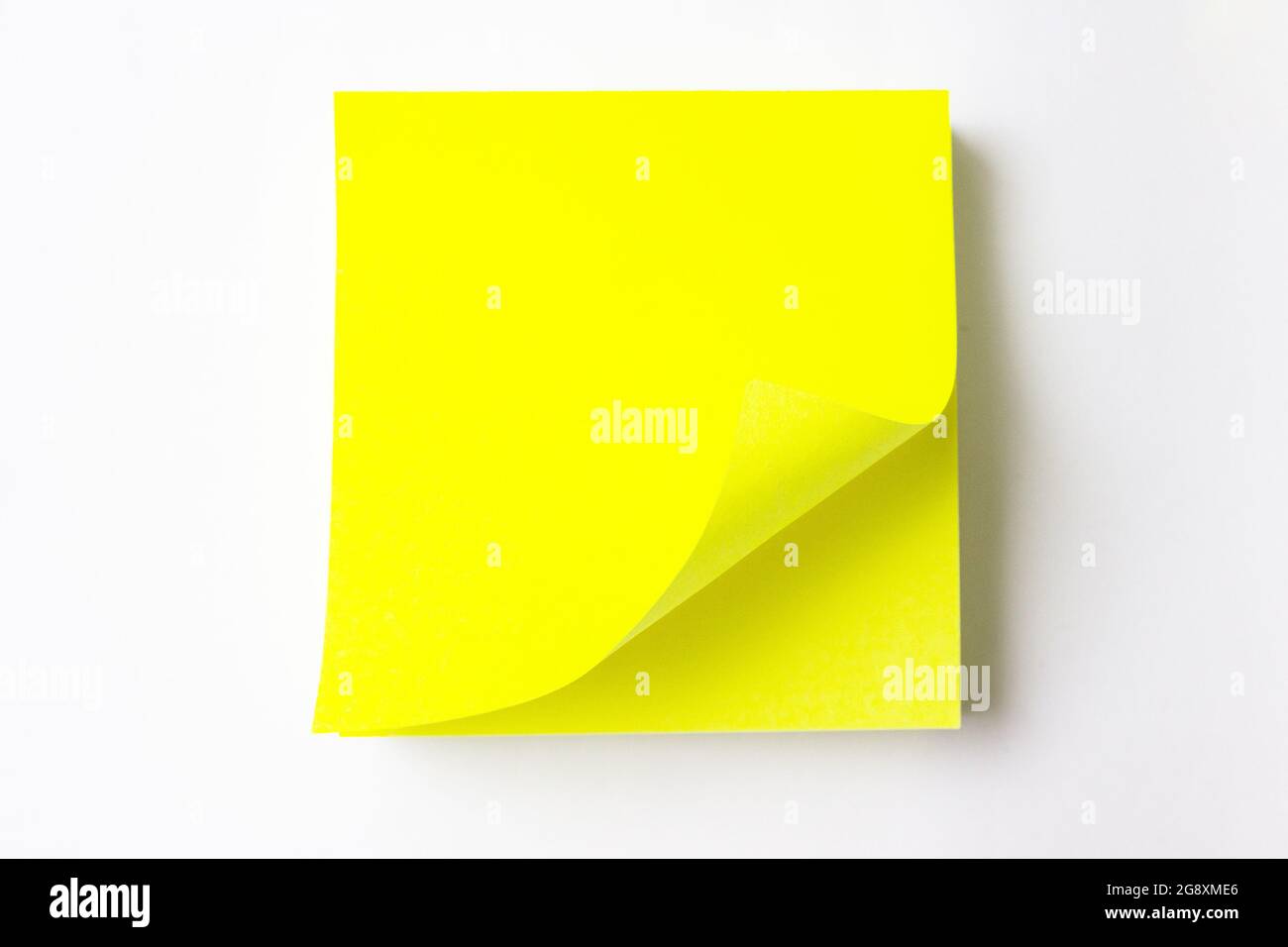 Yellow sticky paper with curled on A White Background Stock Photo - Alamy