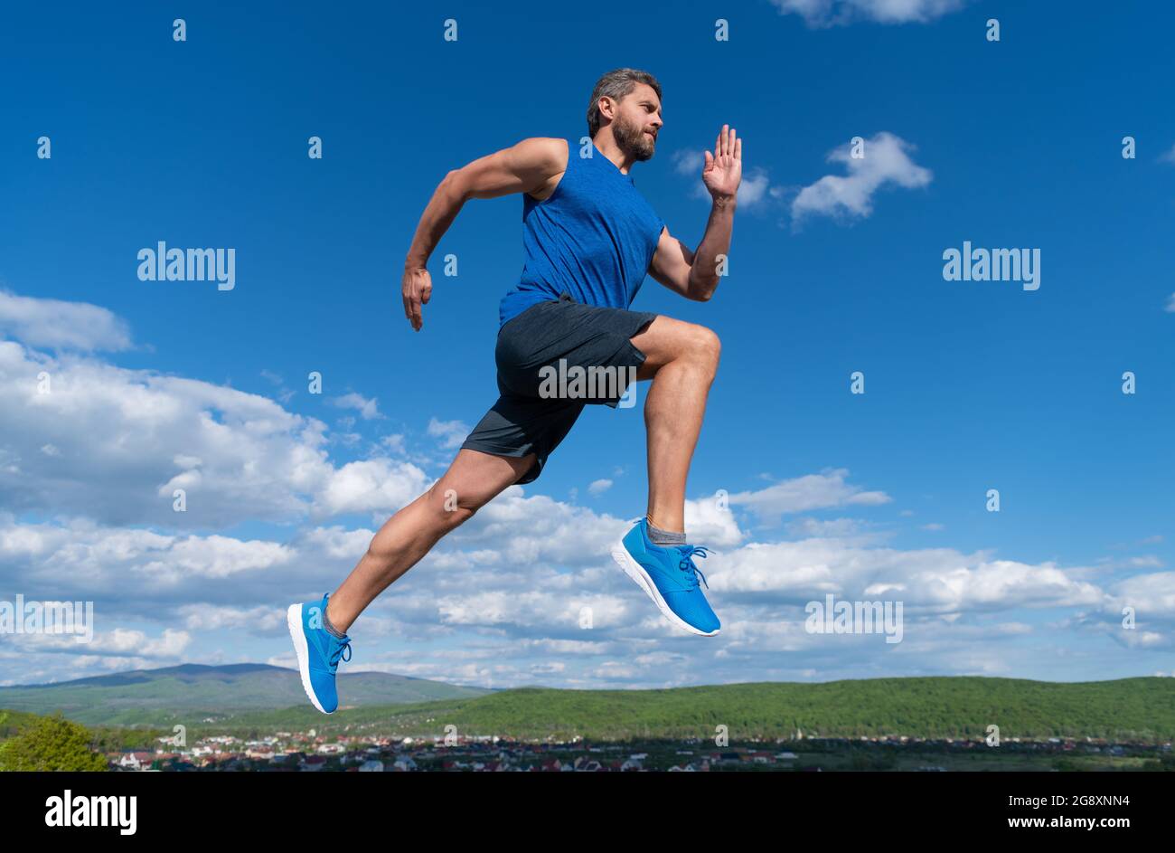 energetic man athlete with muscular body run in sportswear outdoor on ...