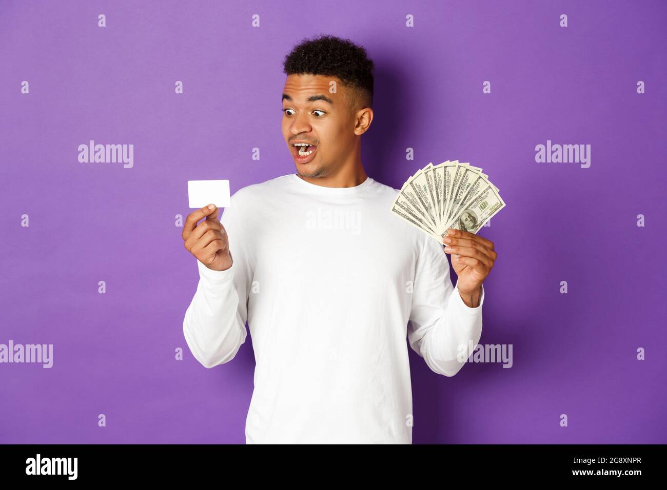 Image of handsome african american guy, showing money and looking ...