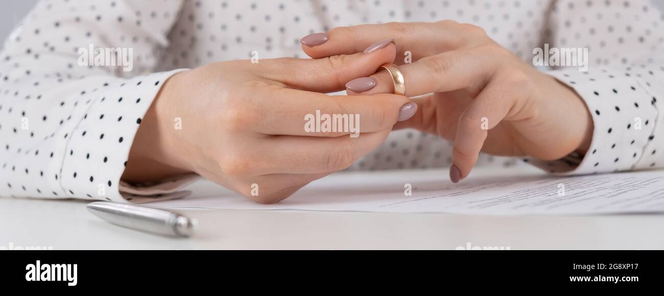 Close-up woman signed divorce papers and took off her wedding ring ...