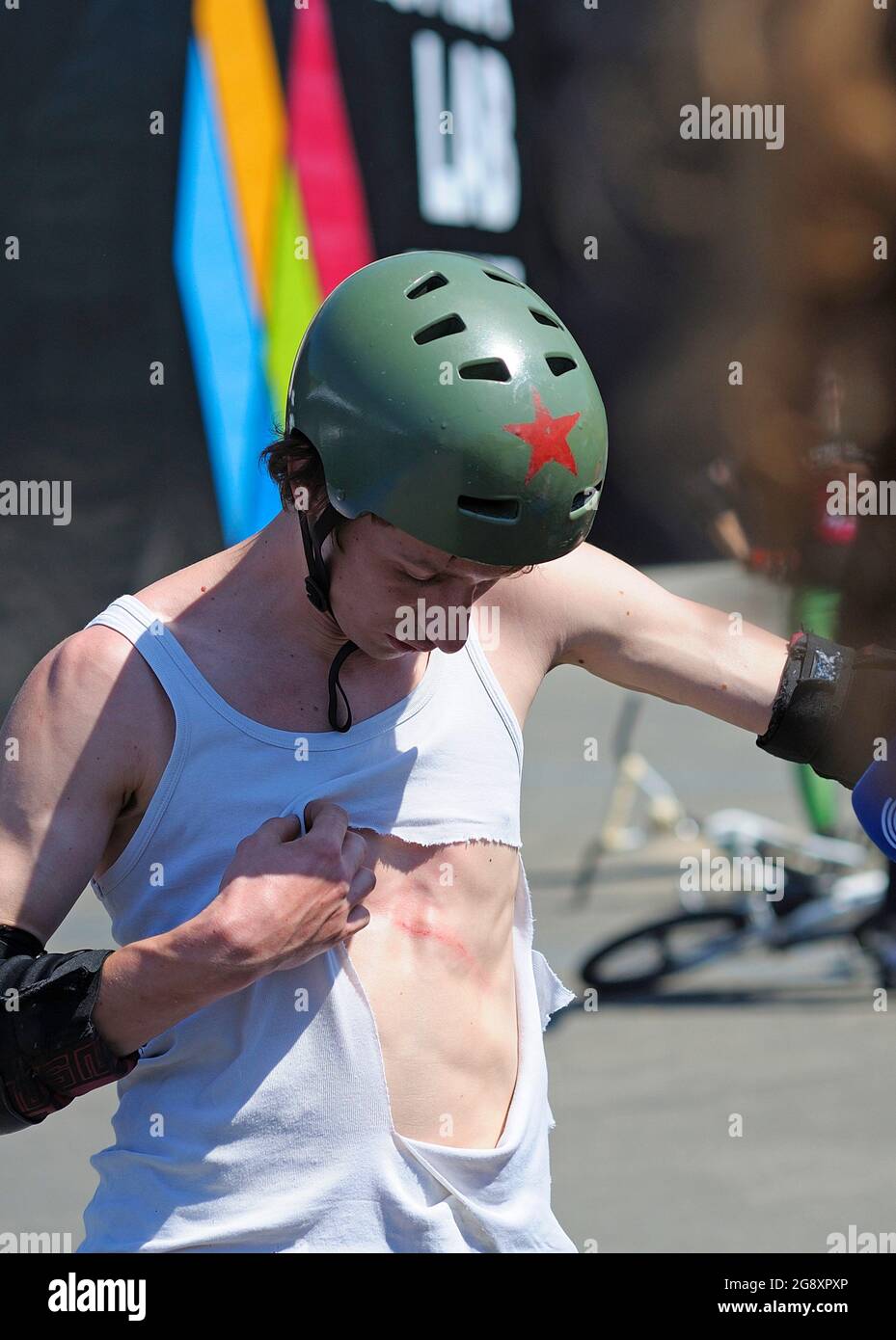 Fun jumping. Young boy, the cycler, showing bruises on his body after ...