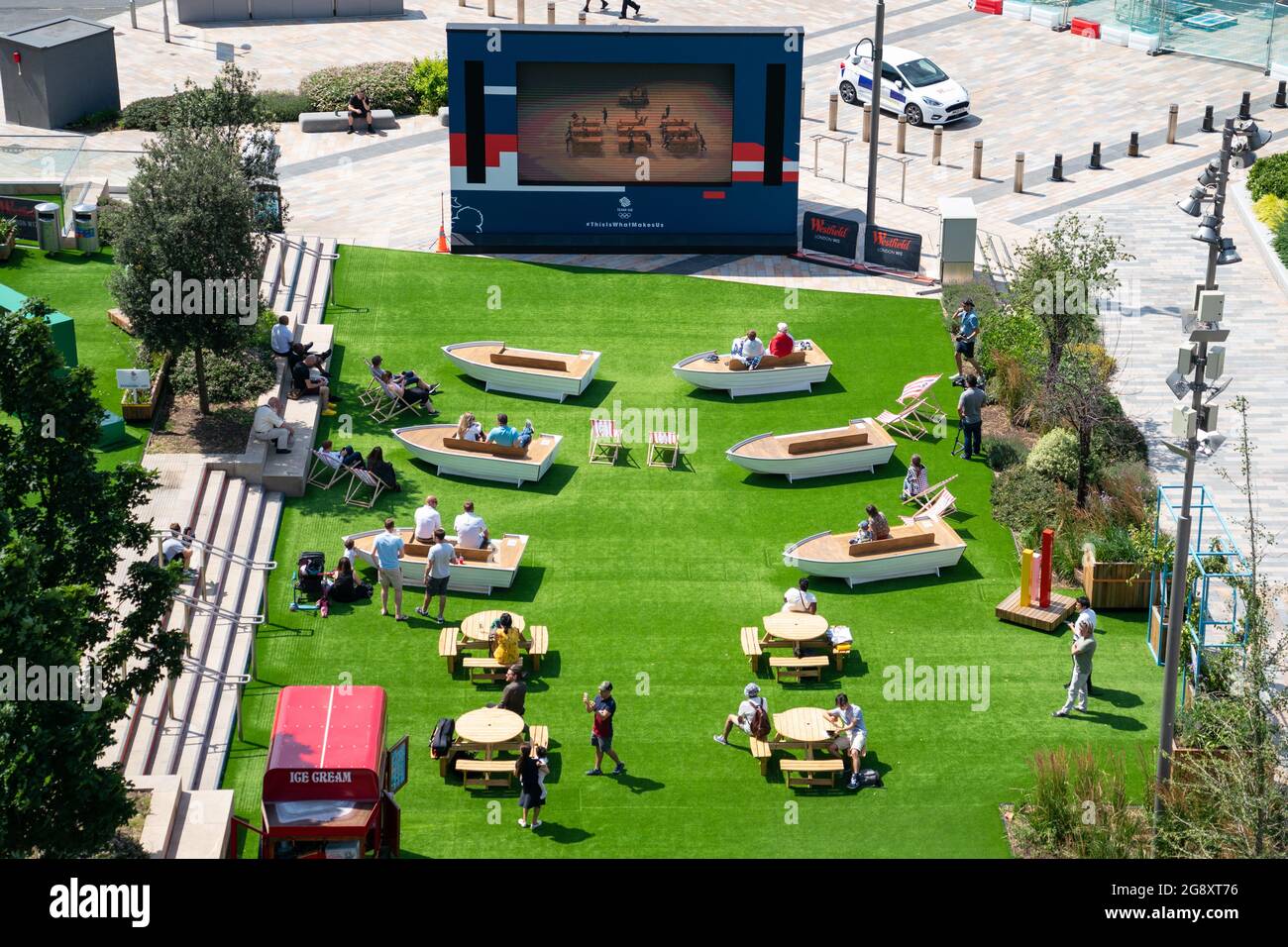 Fans watch the opening ceremony of the Tokyo 2020 Olympic Games on a ...
